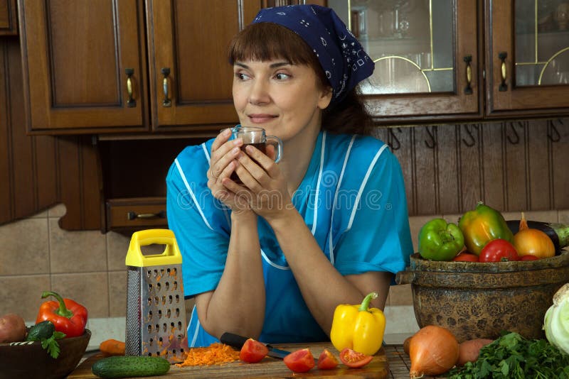 Woman Drinking Tea in the Kitchen among the Vegetables Stock Image ...