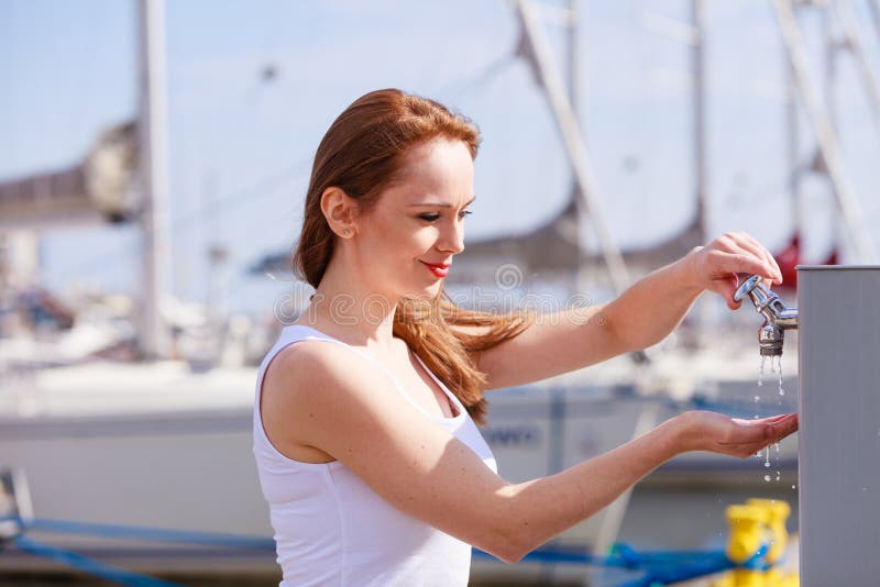 Woman Drinking Water from Tap in Marina Stock Photo - Image of woman ...
