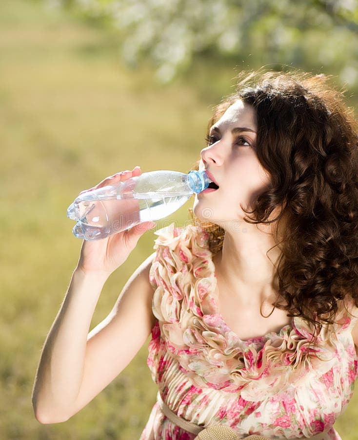 Woman Drinks Cold Water in Spring Garden Stock Photo - Image of adult ...