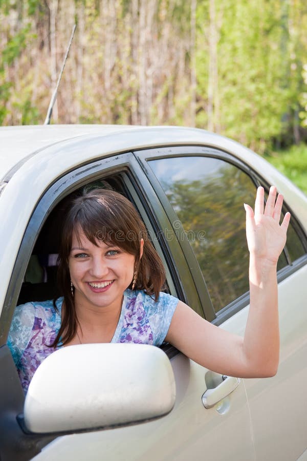 Woman a Driver after the Helm of Car Waves a Hand Stock Photo - Image ...