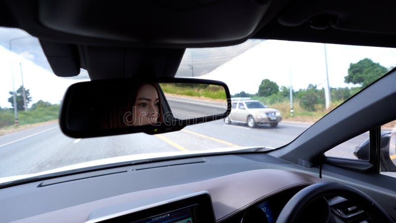 Woman Driving Car Reflects in Rear View Mirror Stock Photo - Image of ...