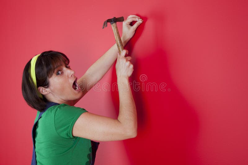 Woman driving a nail stock image. Image of decoration - 26397433