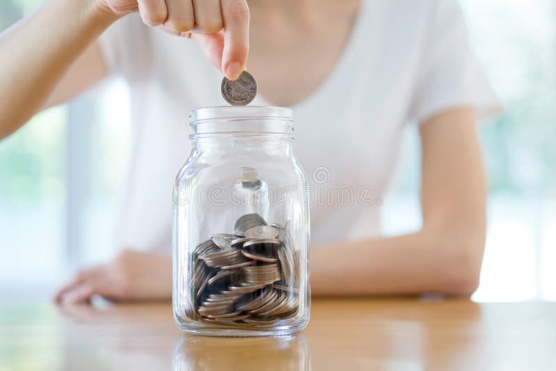 Woman Dropping Coins into Glass Jar Stock Photo - Image of coins, women ...