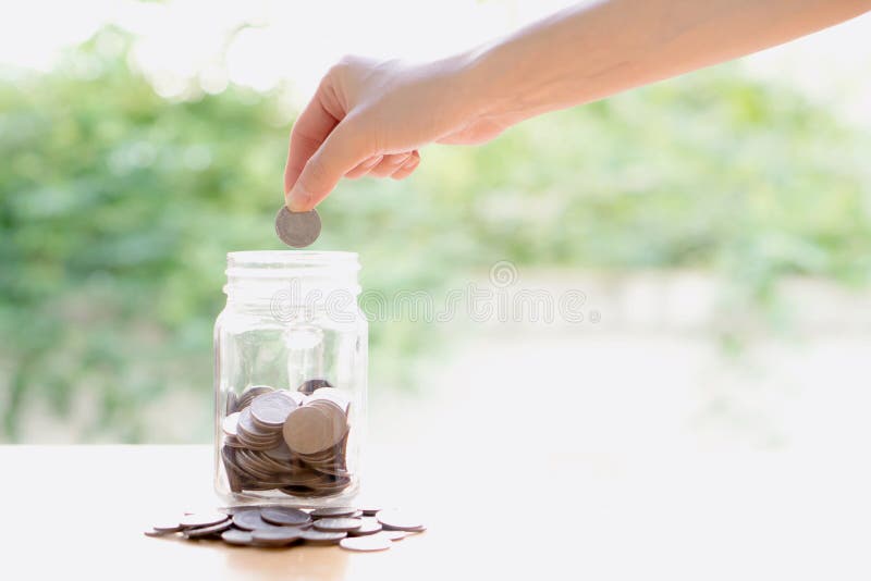 Woman Dropping Coins into a Glass Jar Stock Photo - Image of ideas ...