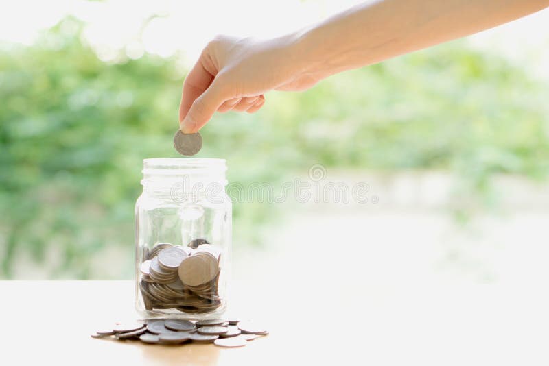 Woman Dropping Coins into Glass Jar Stock Photo - Image of economy ...