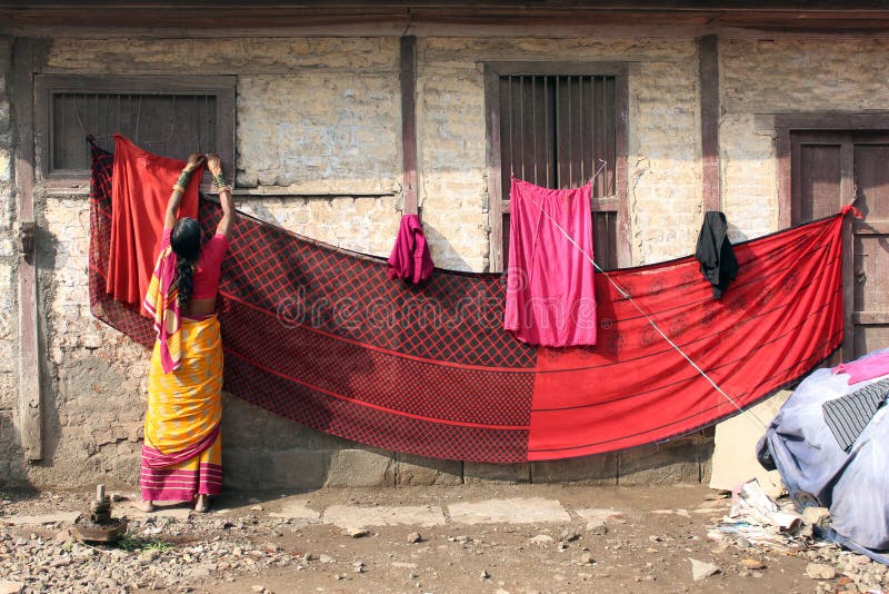 Woman drying clothes editorial photography. Image of house - 193280647