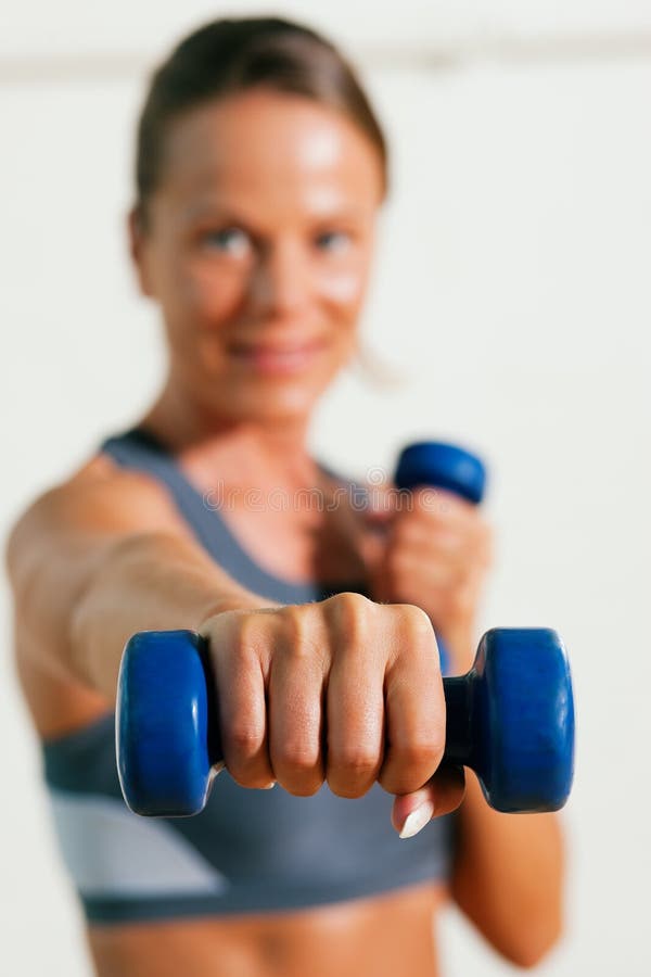 Woman with dumbbell in gym stock photo. Image of person - 15359986