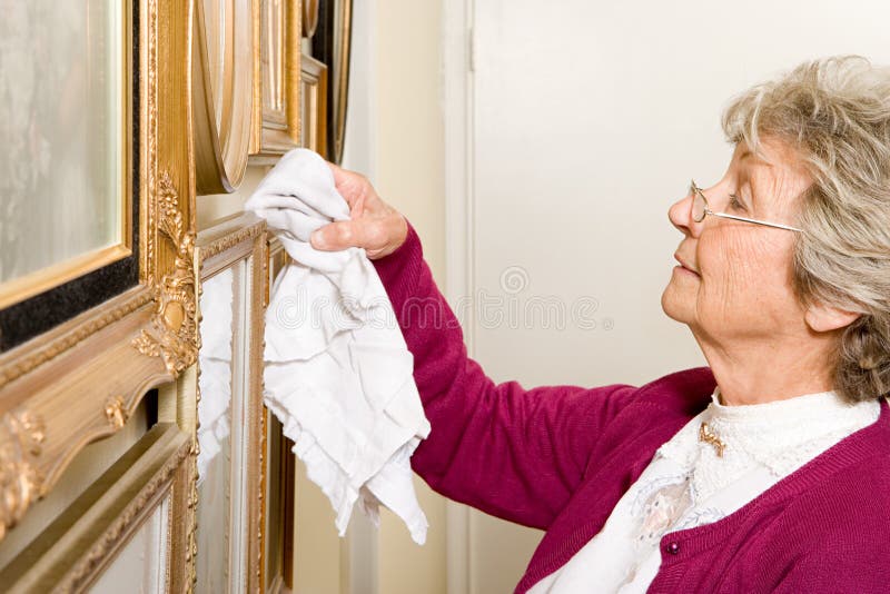 Woman Dusting Picture Frames Stock Photo - Image of house, memories ...