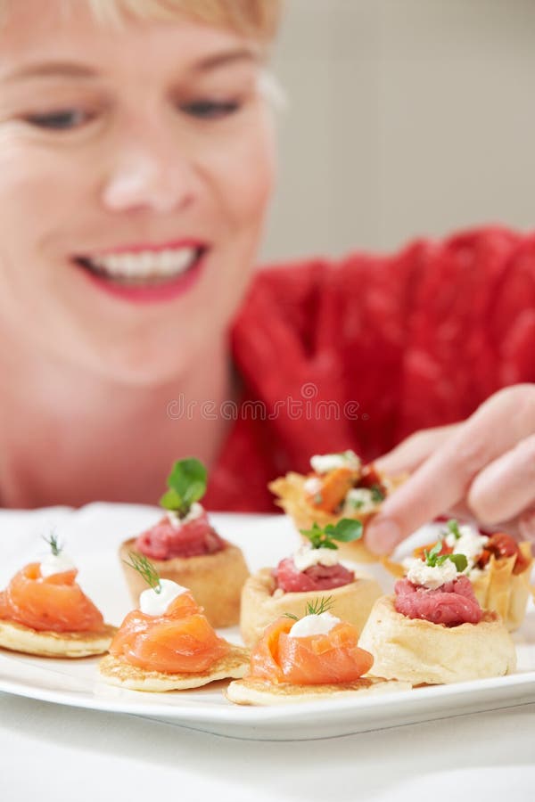 Woman Eating Appetizers on Plate Stock Photo - Image of blini, canape ...