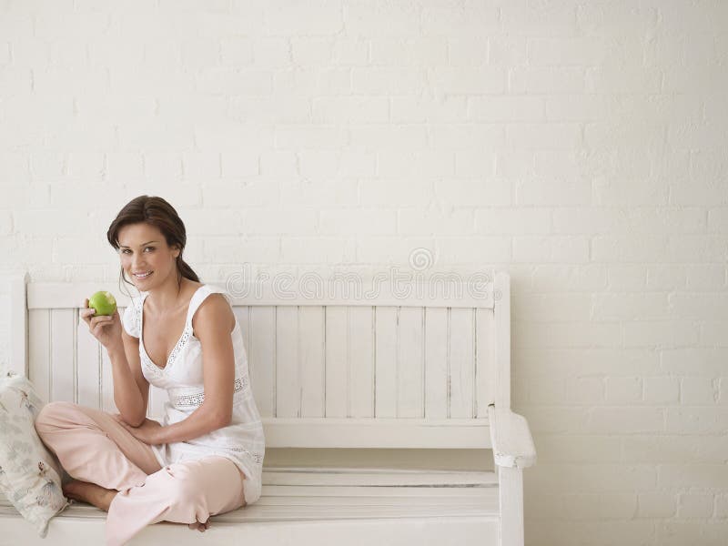 Woman Eating Apple on Bench Stock Photo - Image of bench, eating: 31842040