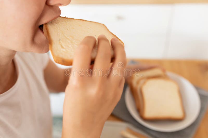 Woman Eating Bread for Breakfast Stock Photo - Image of hungry, hand ...