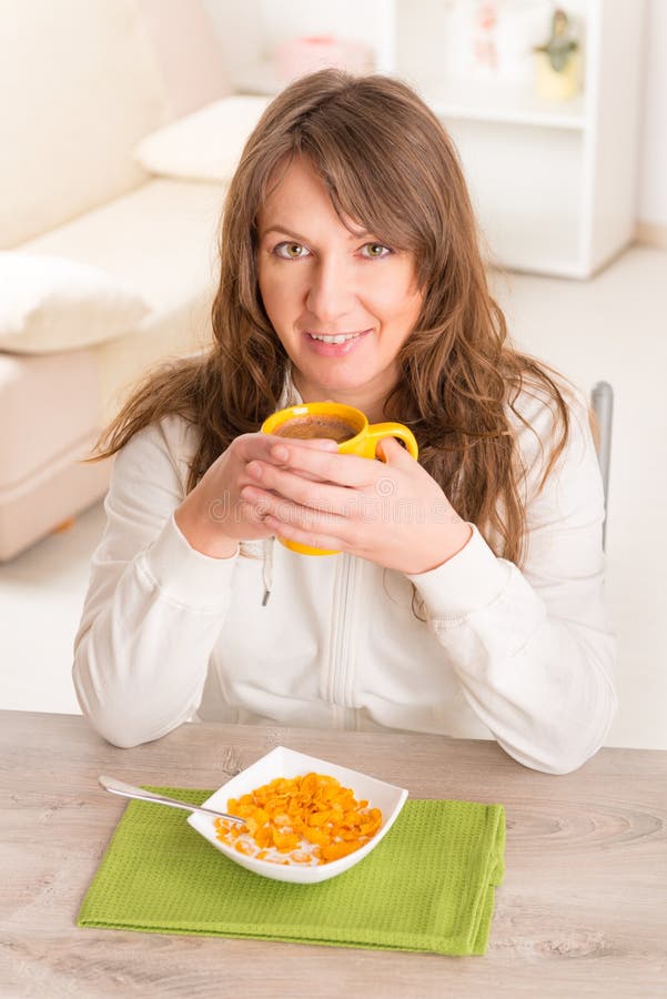 Woman Eating Breakfast at Home Stock Image - Image of coffee, holding ...