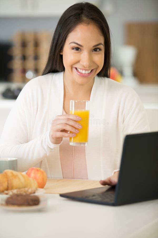 Woman Eating Breakfast Working on Computer Stock Photo - Image of ...