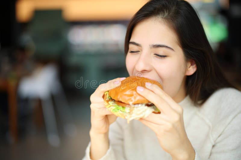 Woman Eating Burger in a Restaurant Stock Image - Image of happy ...