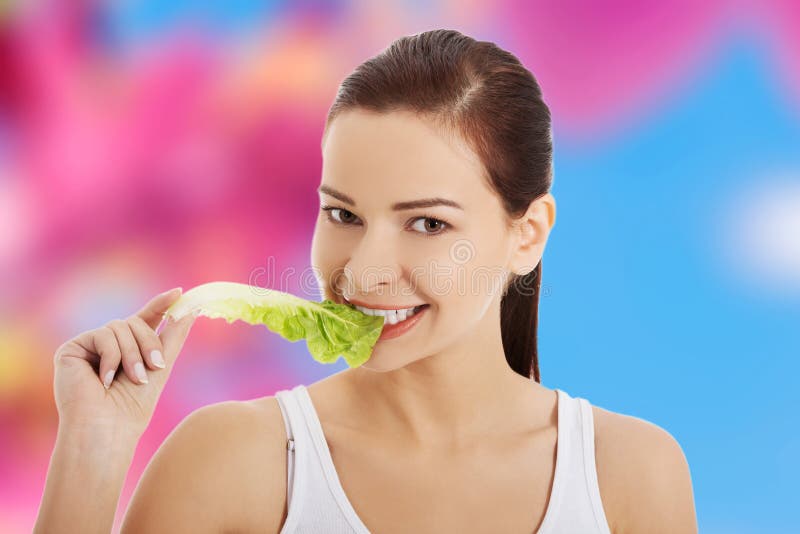 Woman eating a cabbage stock photo. Image of horizontal - 48684894