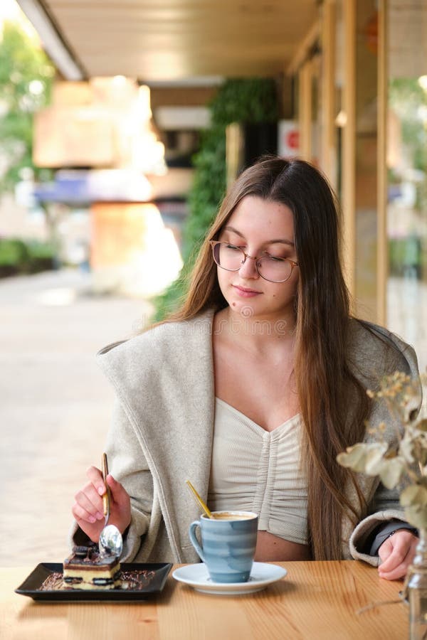 Woman Eating a Cake and Drinking Coffee in a Cafe. Stock Photo - Image ...
