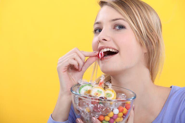 Woman eating candy stock image. Image of sweets, hair - 26585383
