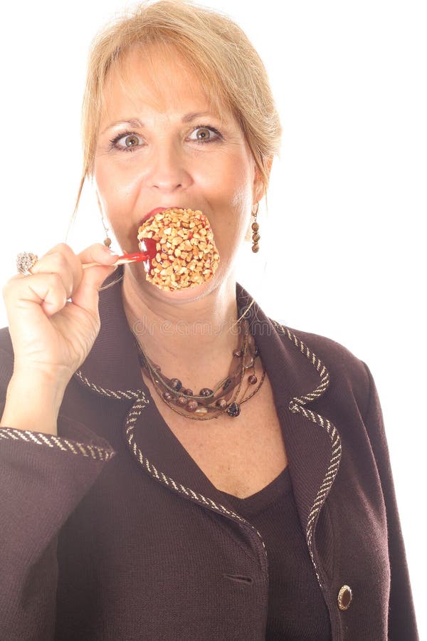 Woman eating candy apple stock photo. Image of blond, happy - 3714470
