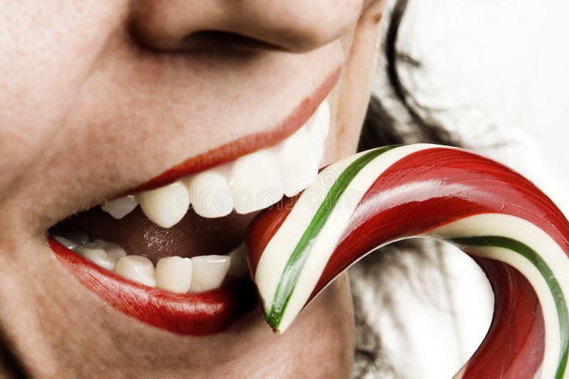 Woman Eating Candy Cane stock photo. Image of allure - 27793674