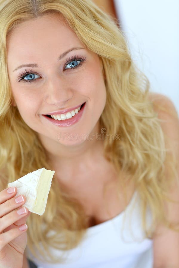Woman eating cheese stock photo. Image of attractive - 28270830