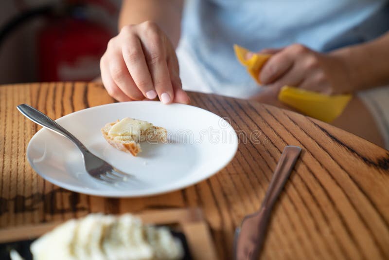 Woman Eating a Cheese and Bread Appetizers on Table at Restaurant Stock ...
