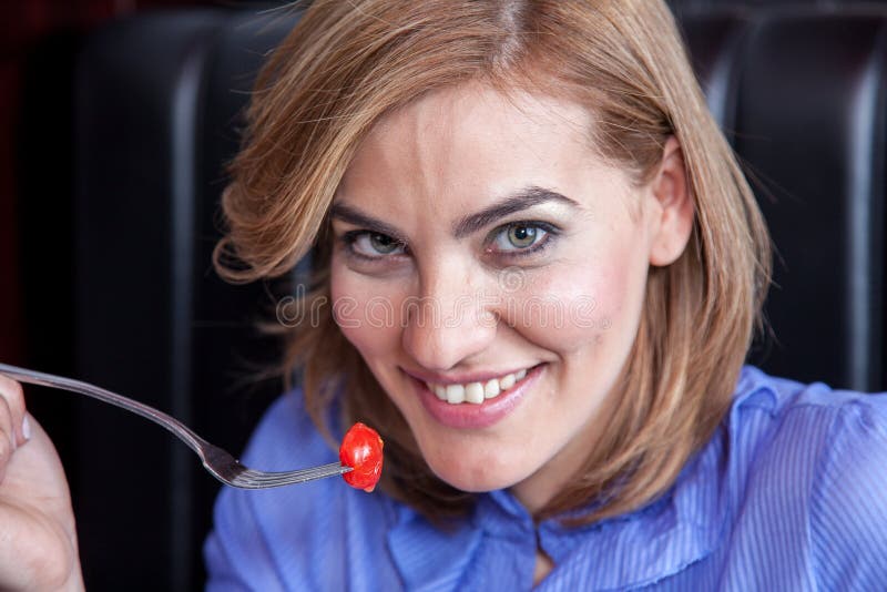 Woman is eating cherry stock photo. Image of smiling - 56617514