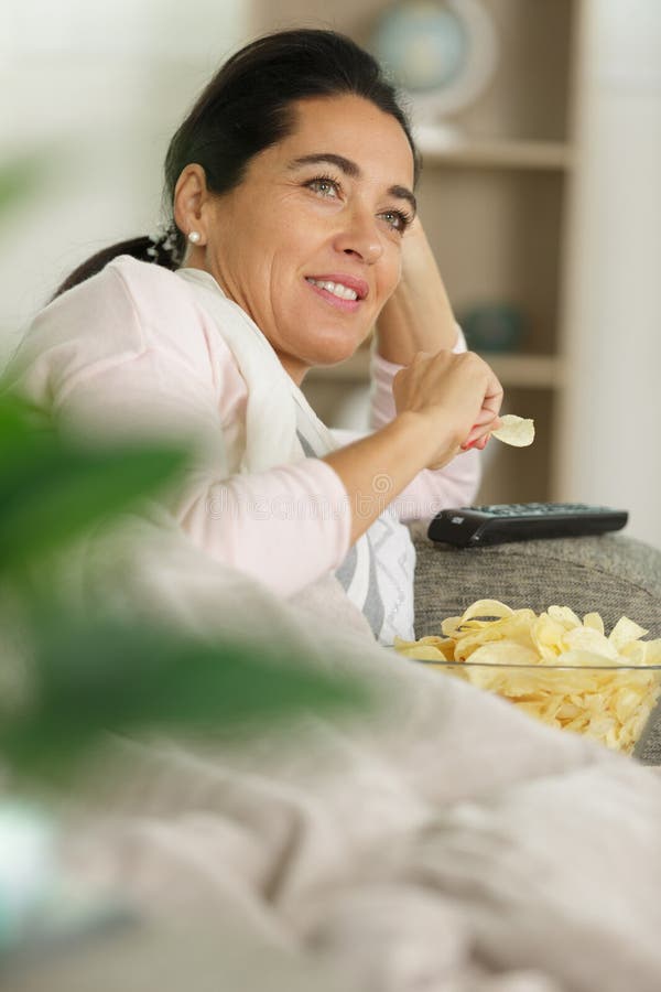 Woman Eating Chips while Watching Tv Stock Photo - Image of delicious, adult: 296715258