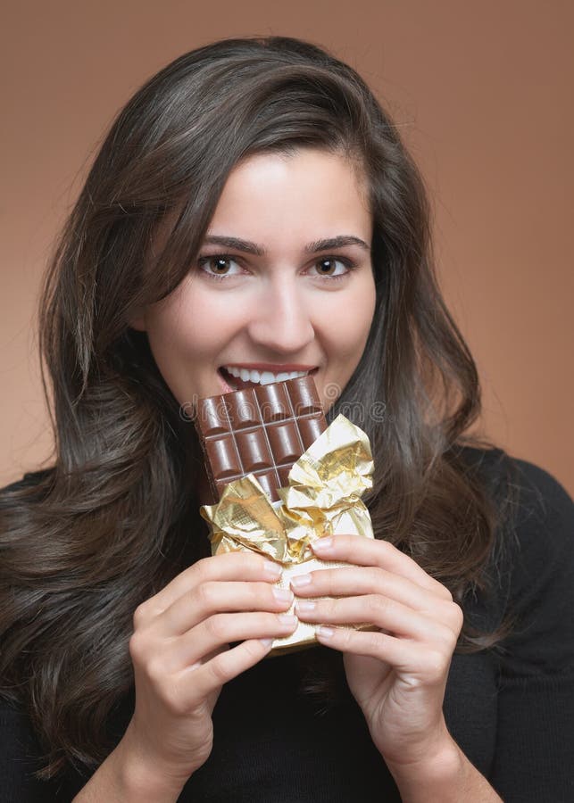 Woman eating chocolate stock image. Image of happy, confectionery ...