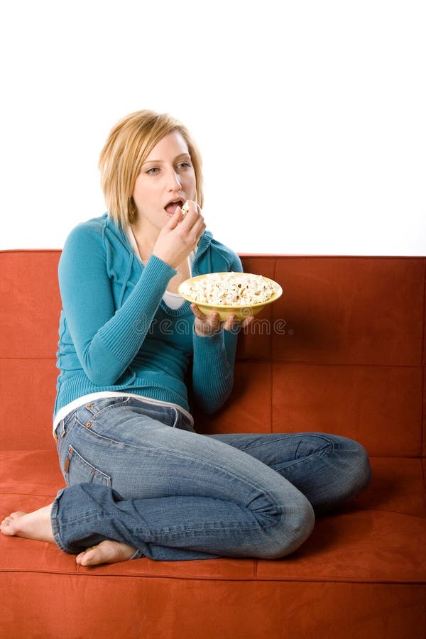 Woman eating on couch stock photo. Image of blue, brown - 2256588
