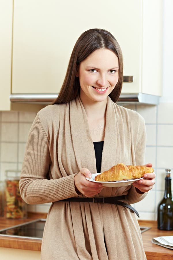 Woman eating a croissant stock photo. Image of happy - 18670700