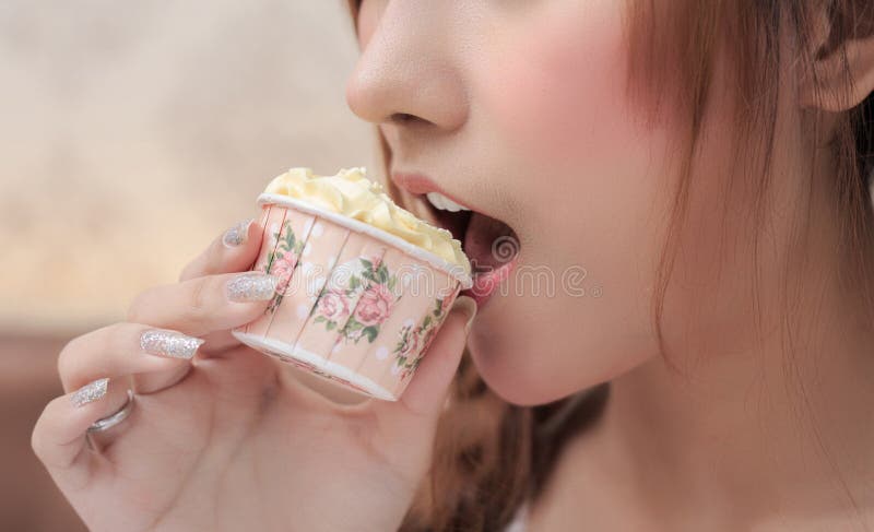 Woman eating cupcake stock photo. Image of hand, close - 82160452