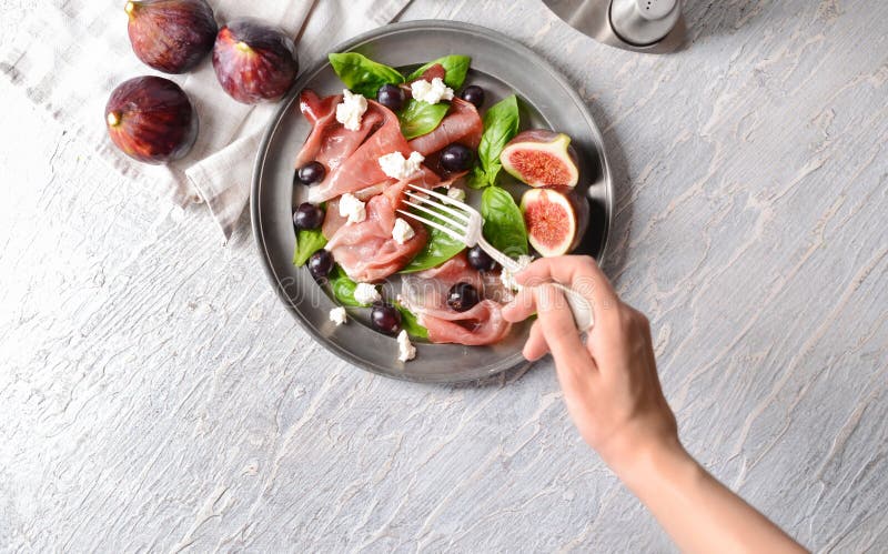 Woman Eating Delicious Fig Salad on Light Background Stock Photo ...