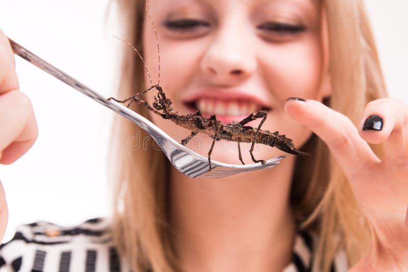 Woman Eating Insects with a Fork in a Restaurant Stock Image - Image of ...