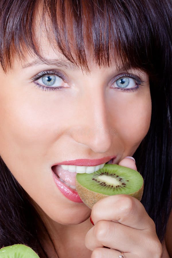 Woman eating kiwi stock image. Image of kiwi, hold, hand - 20588879