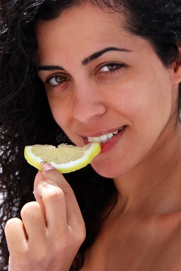 Woman eating lemon stock photo. Image of brunette, look - 14507126