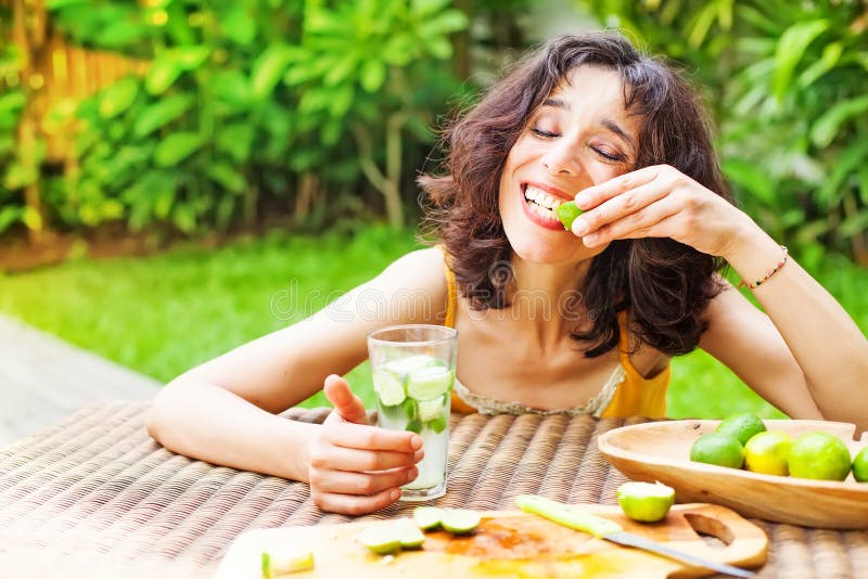 Woman eating a lemon stock image. Image of healthy, fresh - 61743845