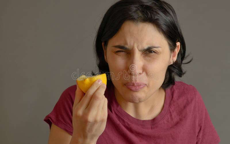 Woman Eating Lemon and Making Silly Faces Isolated Stock Image - Image ...