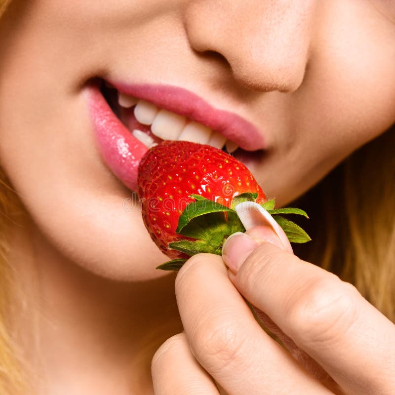 Woman tasting a strawberry stock photo. Image of finger - 47652