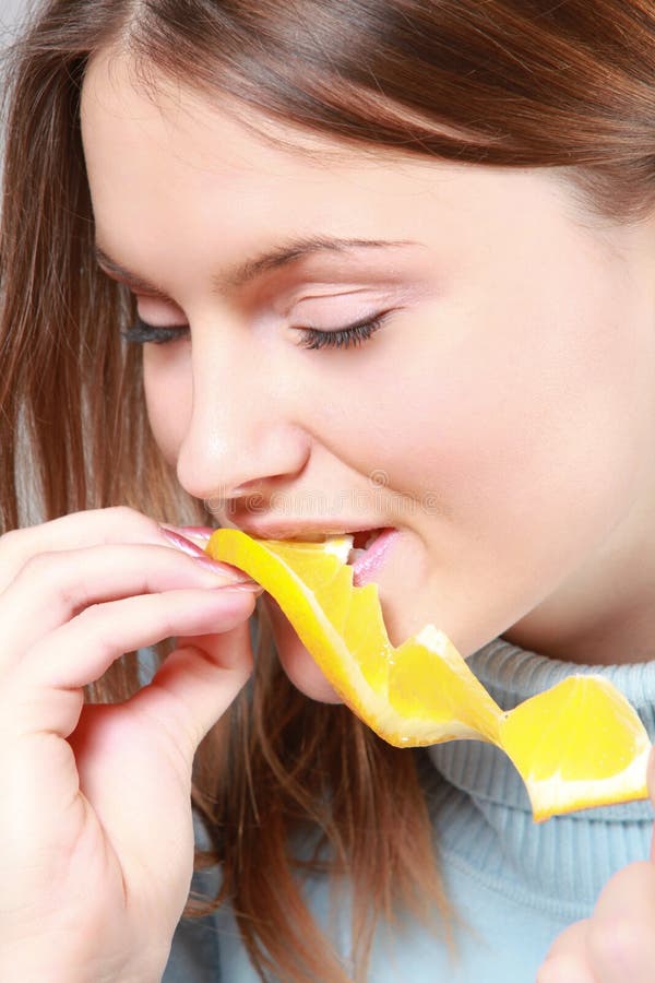 Woman eating orange stock image. Image of portrait, white - 12014293