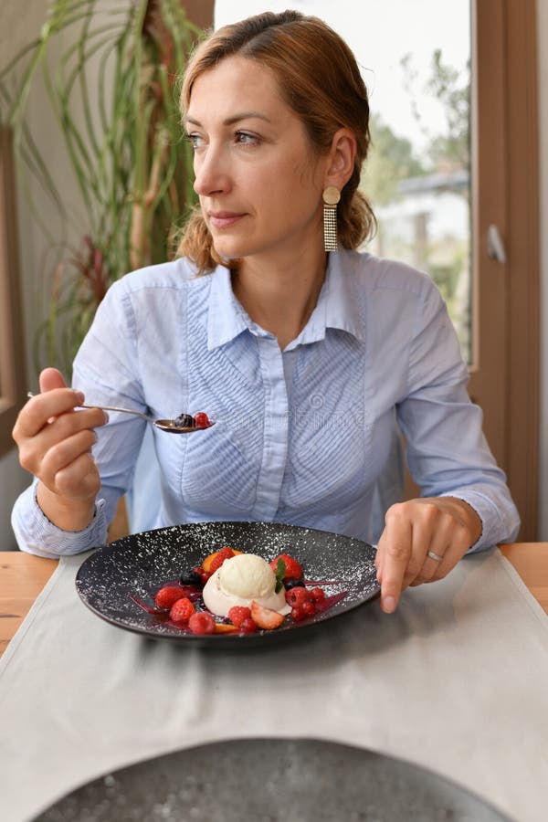 Woman Eating Panna Cotta at a Restaurant Stock Photo - Image of green ...