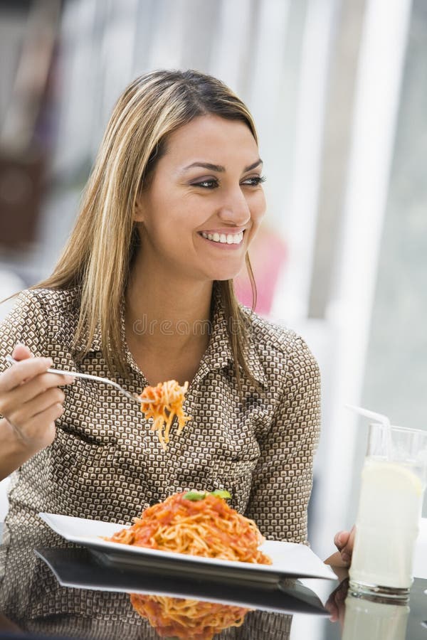 Woman eating pasta at cafe stock photo. Image of pasta - 5211194
