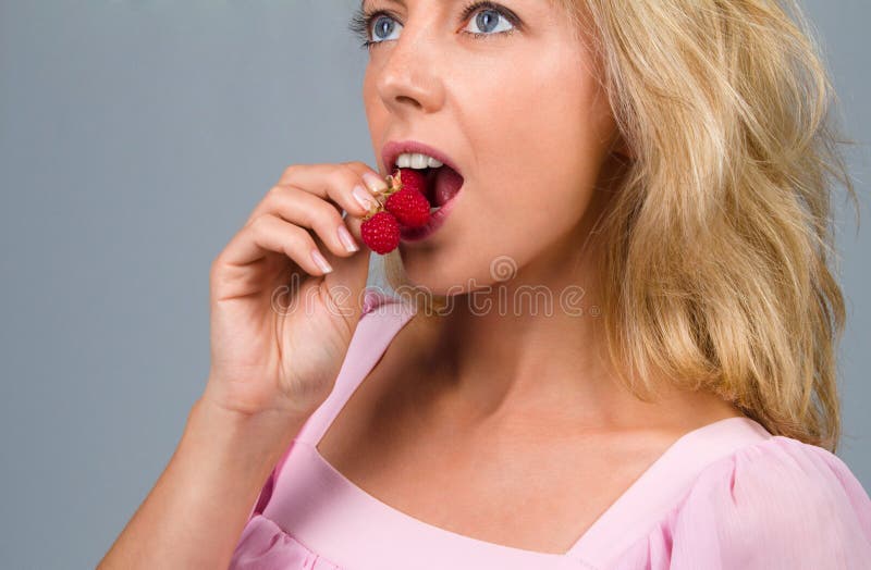 Woman eating raspberries stock photo. Image of healthy - 43932018