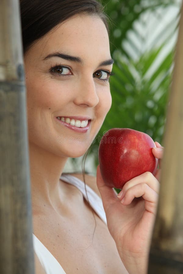 Woman eating a red apple stock image. Image of hand, dentistry - 33940117