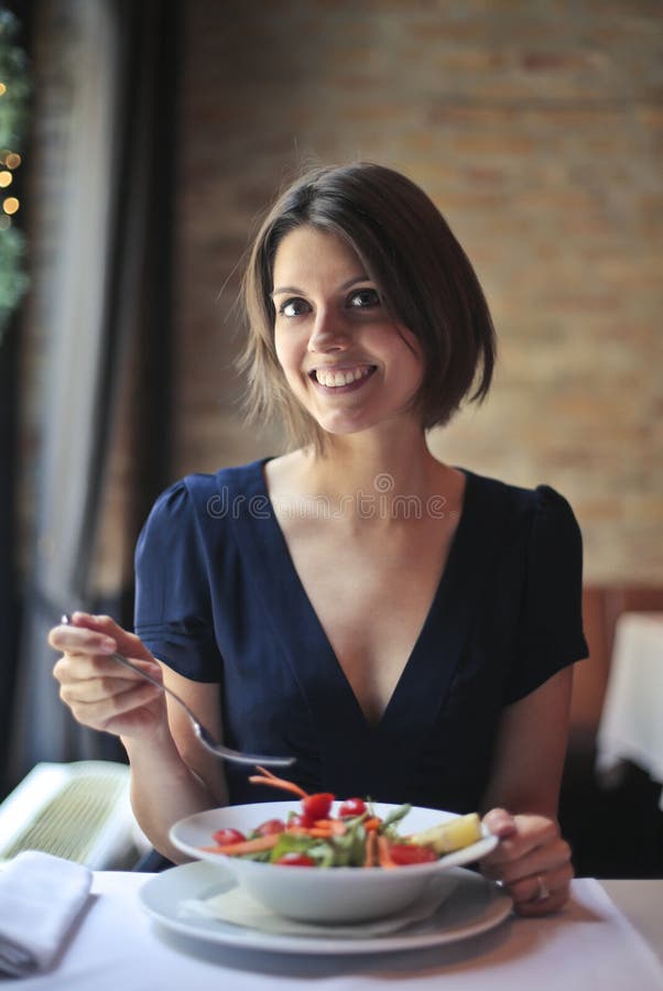 Woman Eating at a Restaurant Stock Image - Image of happiness, elegant ...