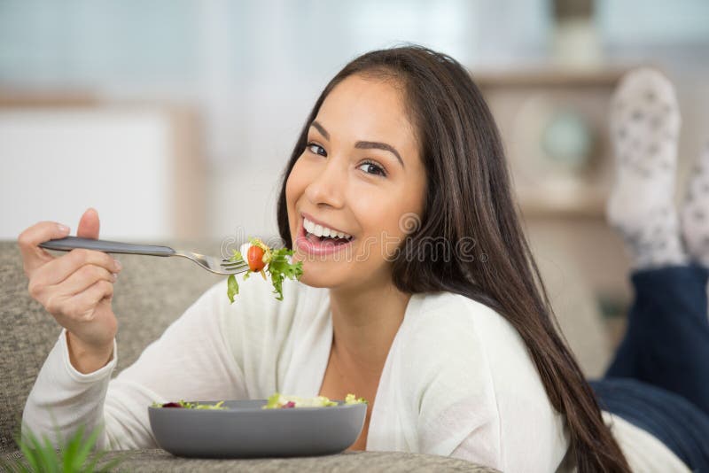 Woman Eating Salad while Laying on Sofa Stock Photo - Image of fresh ...