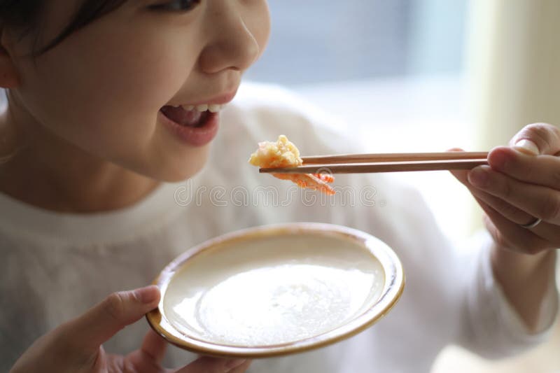 Woman eating shrimp tail stock photo. Image of meal - 325339394