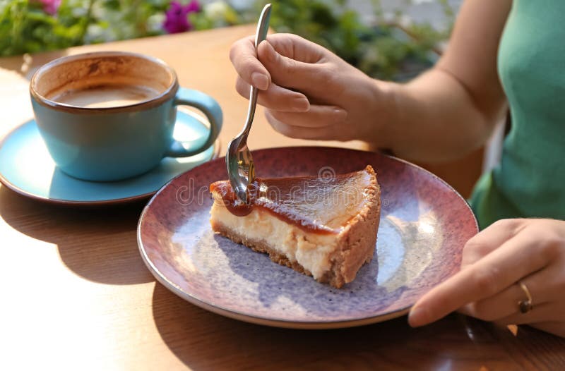 Woman Eating Slice of Cake at Table Stock Photo - Image of bakery ...