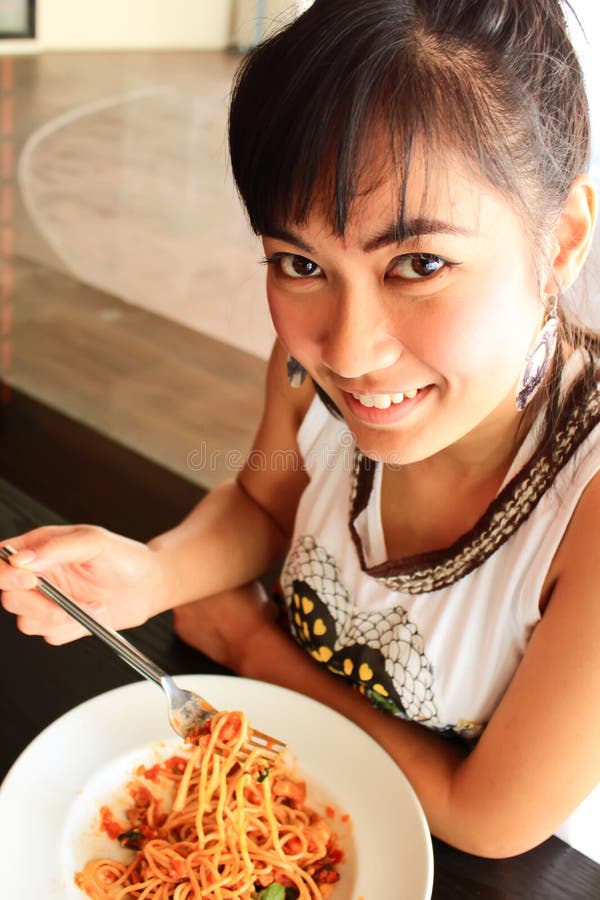Woman eating spaghetti stock image. Image of cafe, people - 21362819