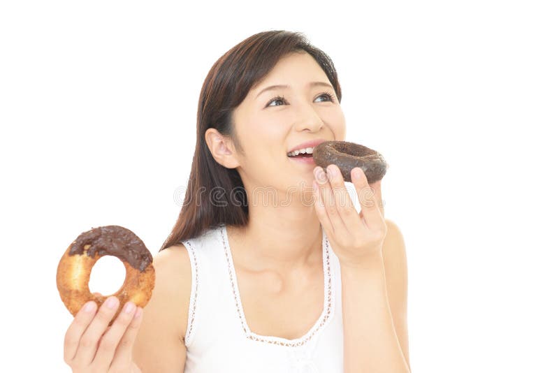 Woman eating sweets stock photo. Image of favorite, female - 145445484