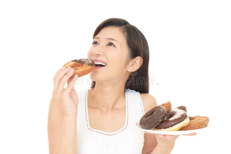 Woman eating sweets stock image. Image of expression - 92729183